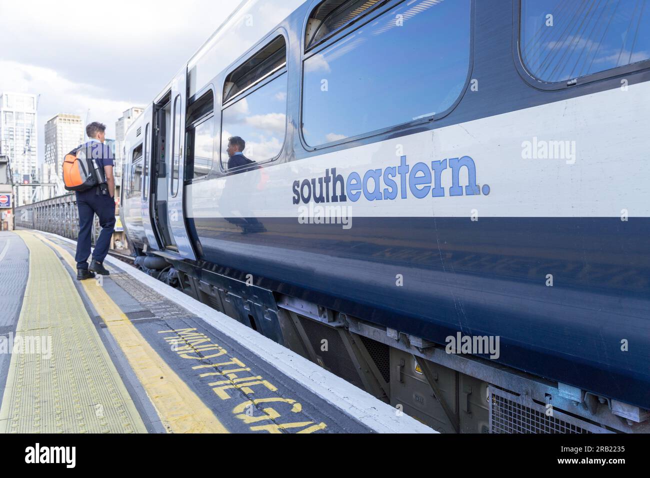 London UK. 5th July. A traveller is about to board Southeastern railway ...