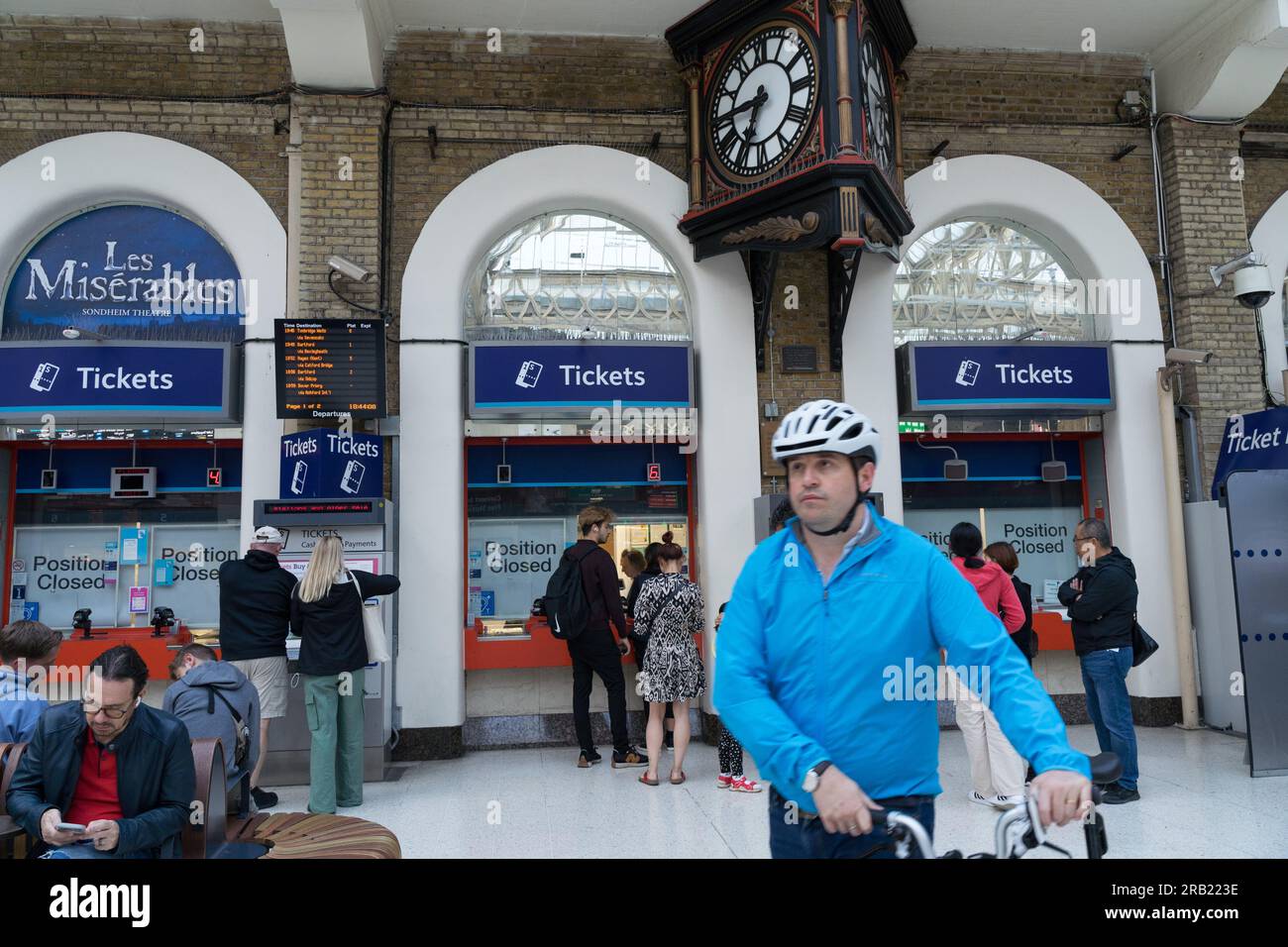 London UK. 5th July. Commuters and travellers queue for their turn at ...