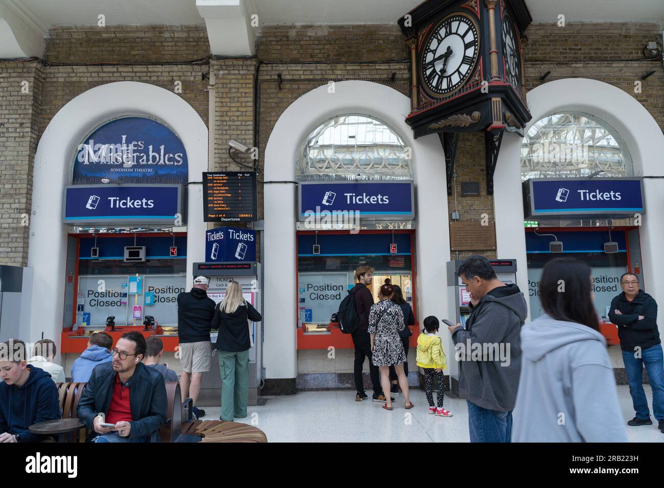 London UK. 5th July. Commuters and travellers queue for their turn at ...