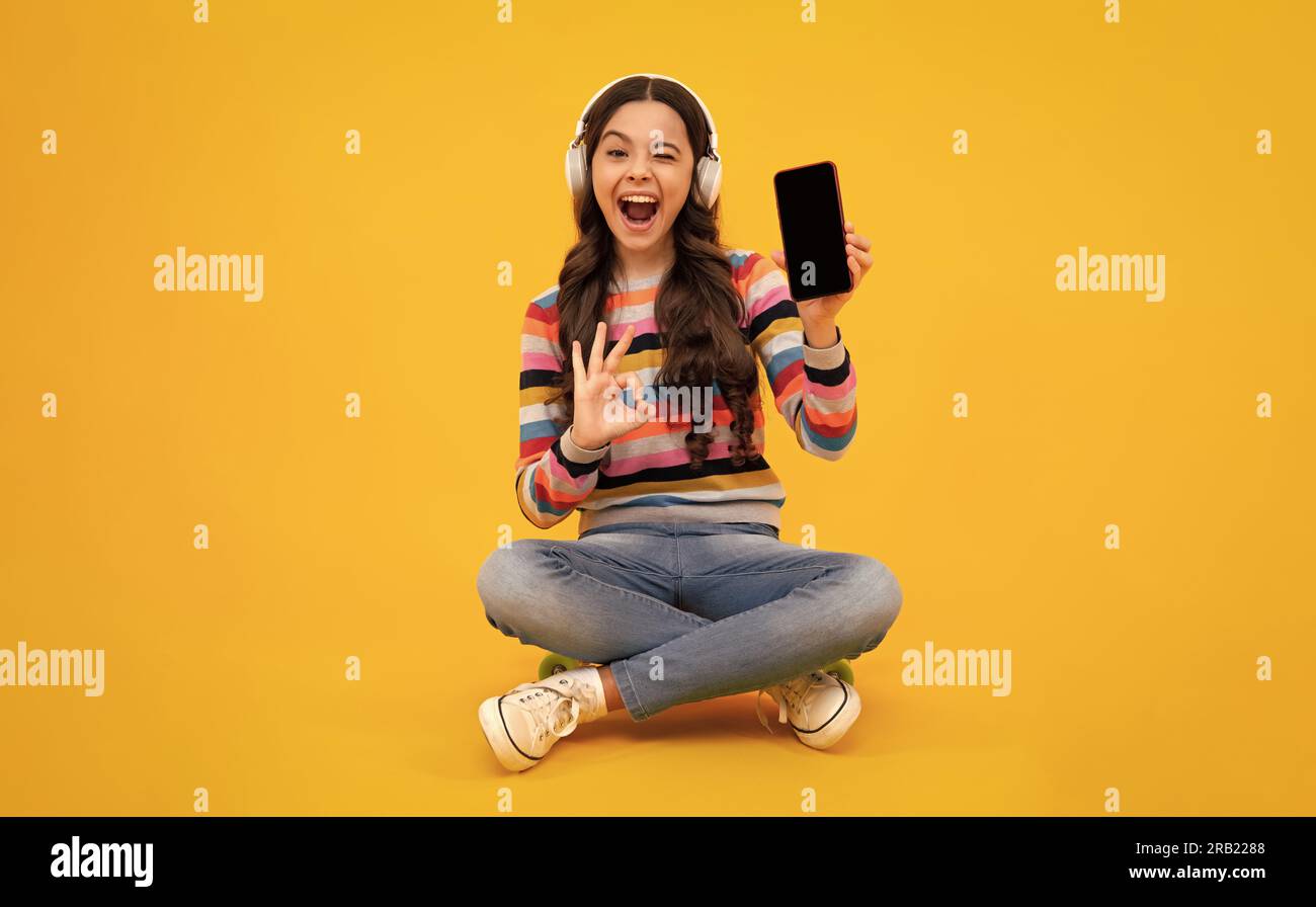 Portrait of cute teenage girl using mobile phone, chatting on web ...