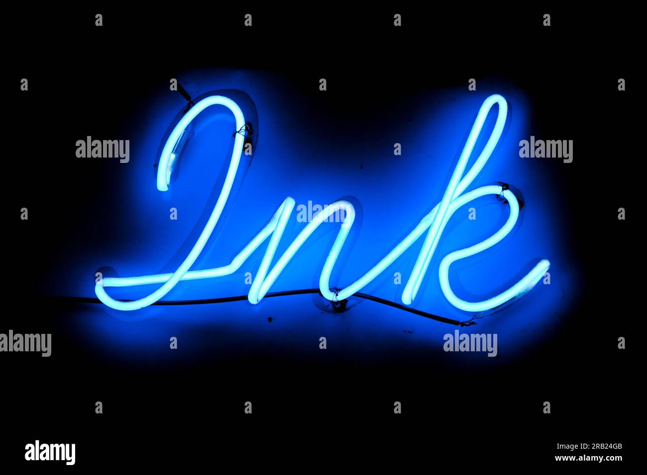 A blue neon light shaped into the word "Ink Stock Photo - Alamy