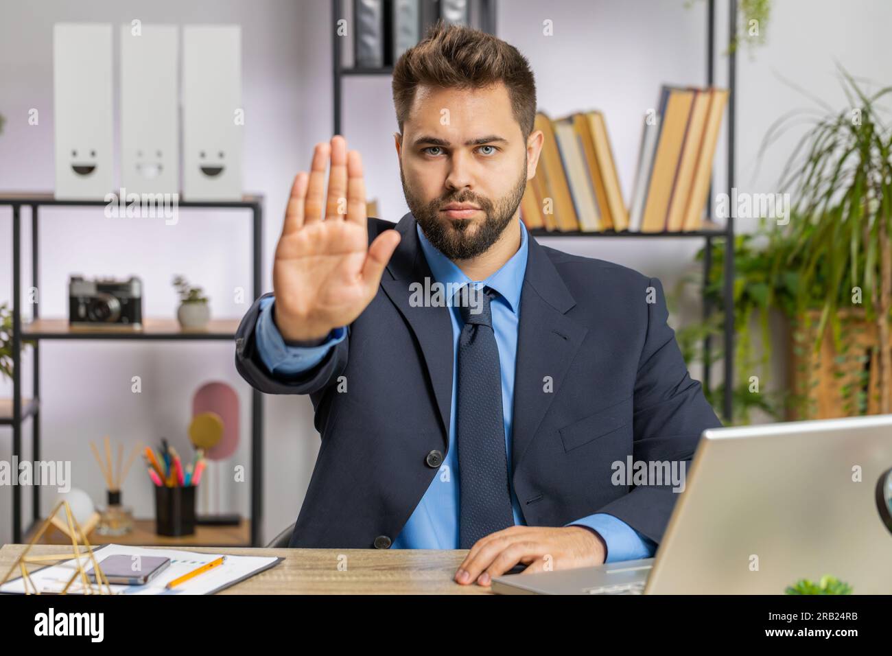 Stop. Caucasian businessman guy working on laptop, warning of finish ...