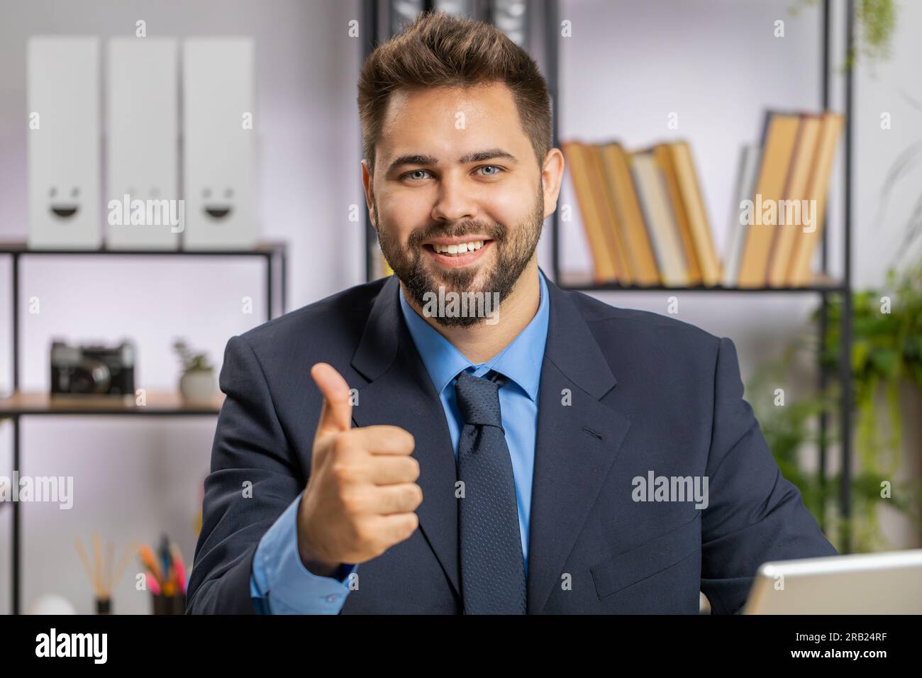 Like. Happy young Caucasian businessman guy working on laptop looking ...
