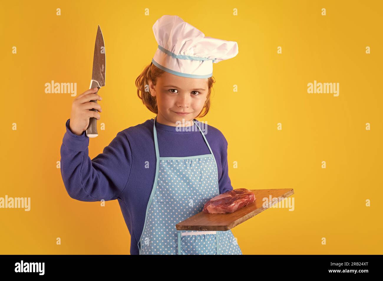 Kid cook hold cutting board with meat beef steak and knife. Chef kid ...