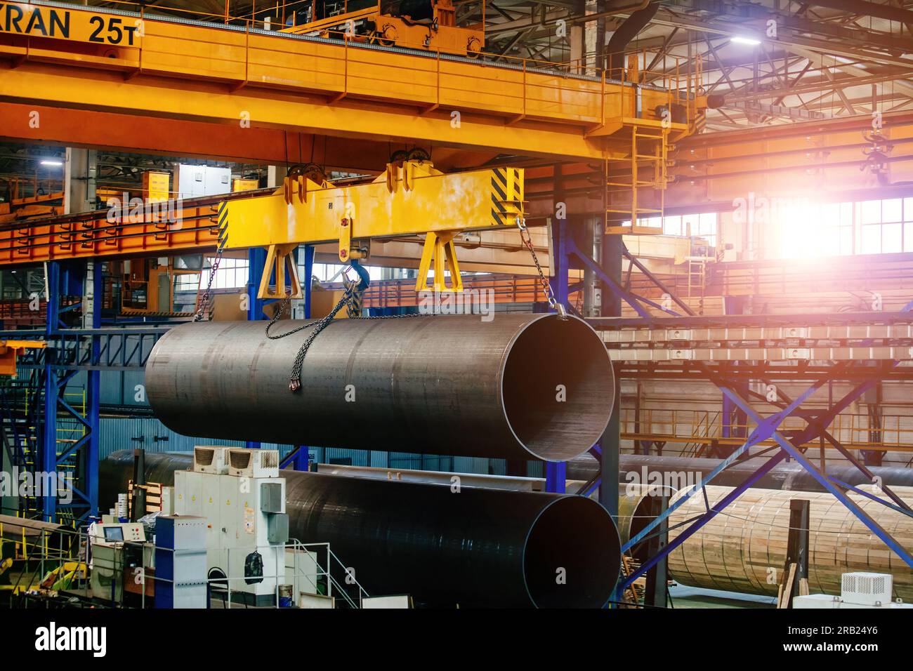 Finished pipe transportation by overhead crane in pipe factory Stock ...