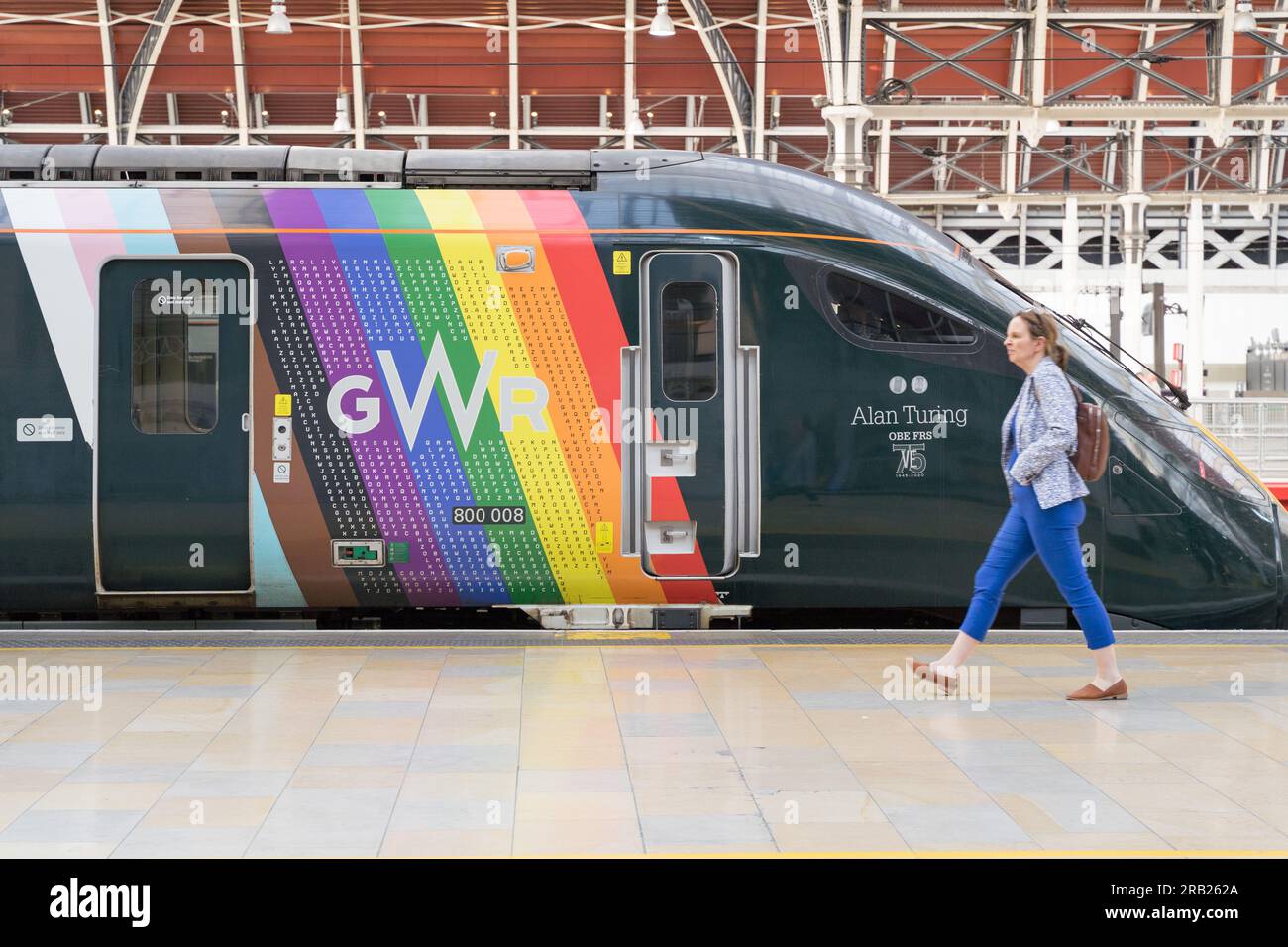 London UK. 5th July. WOman passenger walks beside the GWR train ...