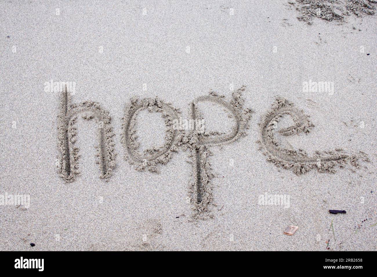The word Hope is written in the sand Stock Photo - Alamy