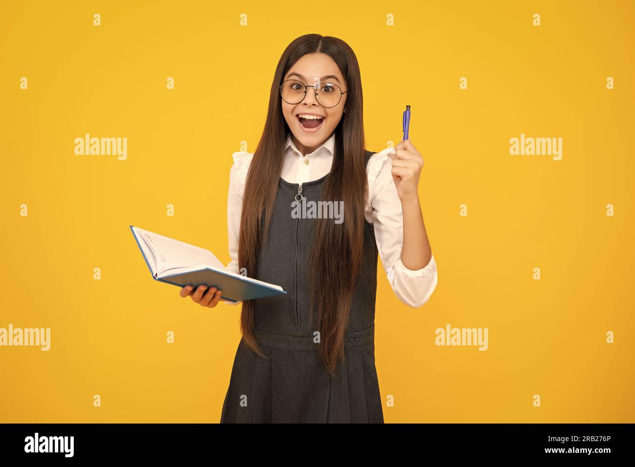 Teenager school girl with books isolated studio background. Surprised ...