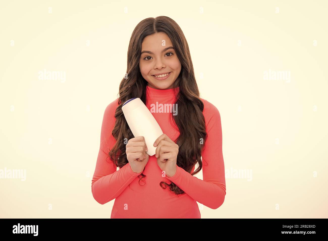 Child teen girl with shampoos conditioners and shower gel. Long hair ...