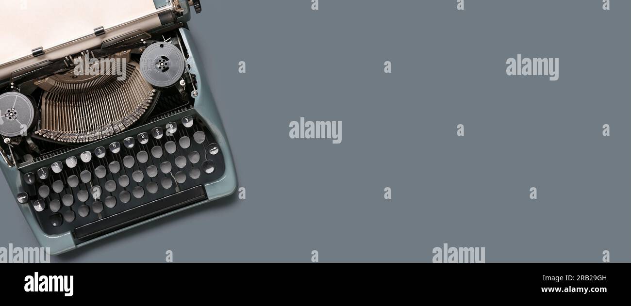 Vintage typewriter with paper sheet on grey background. Banner for ...