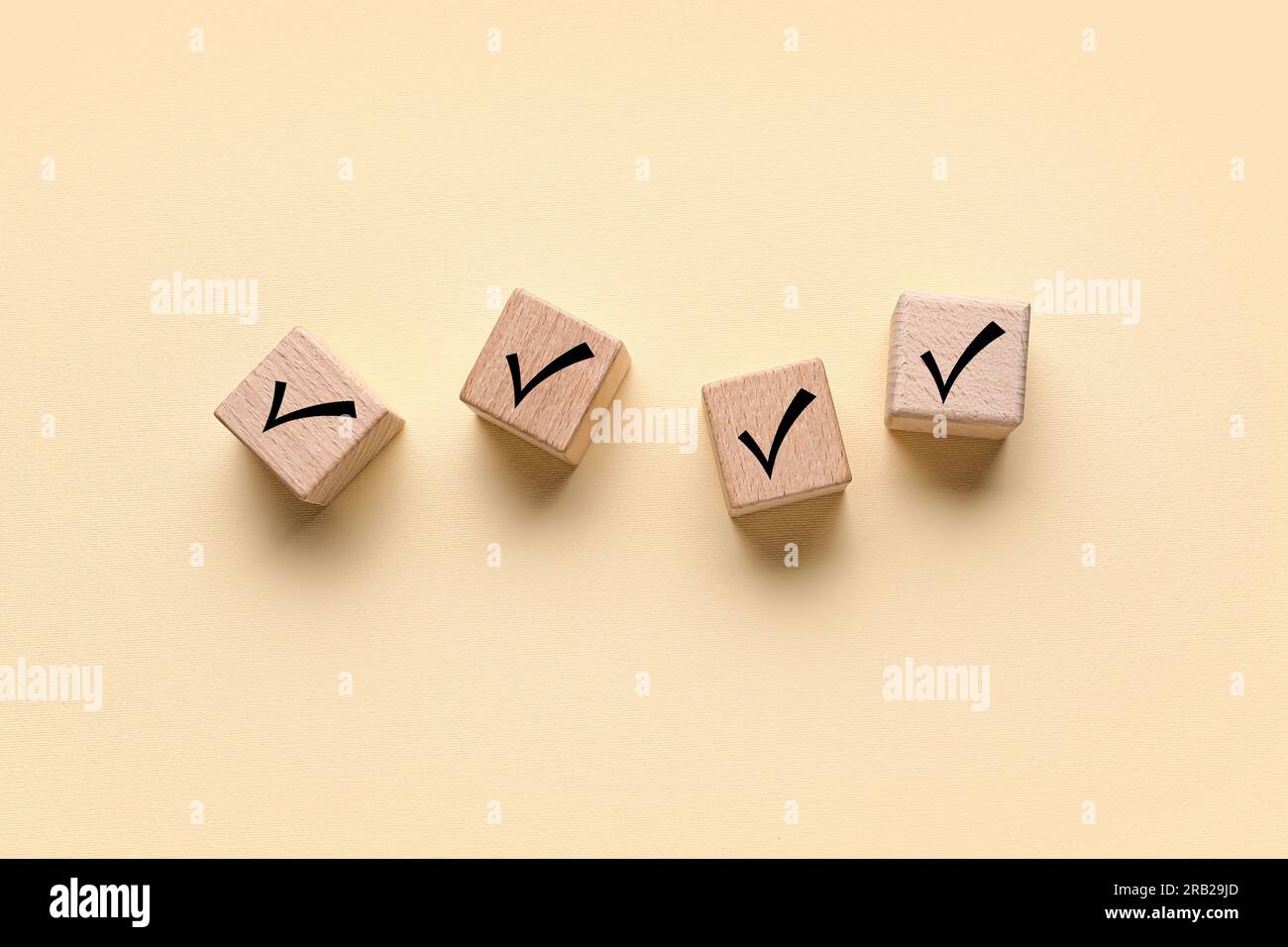 Wooden cubes with check marks on light background Stock Photo - Alamy