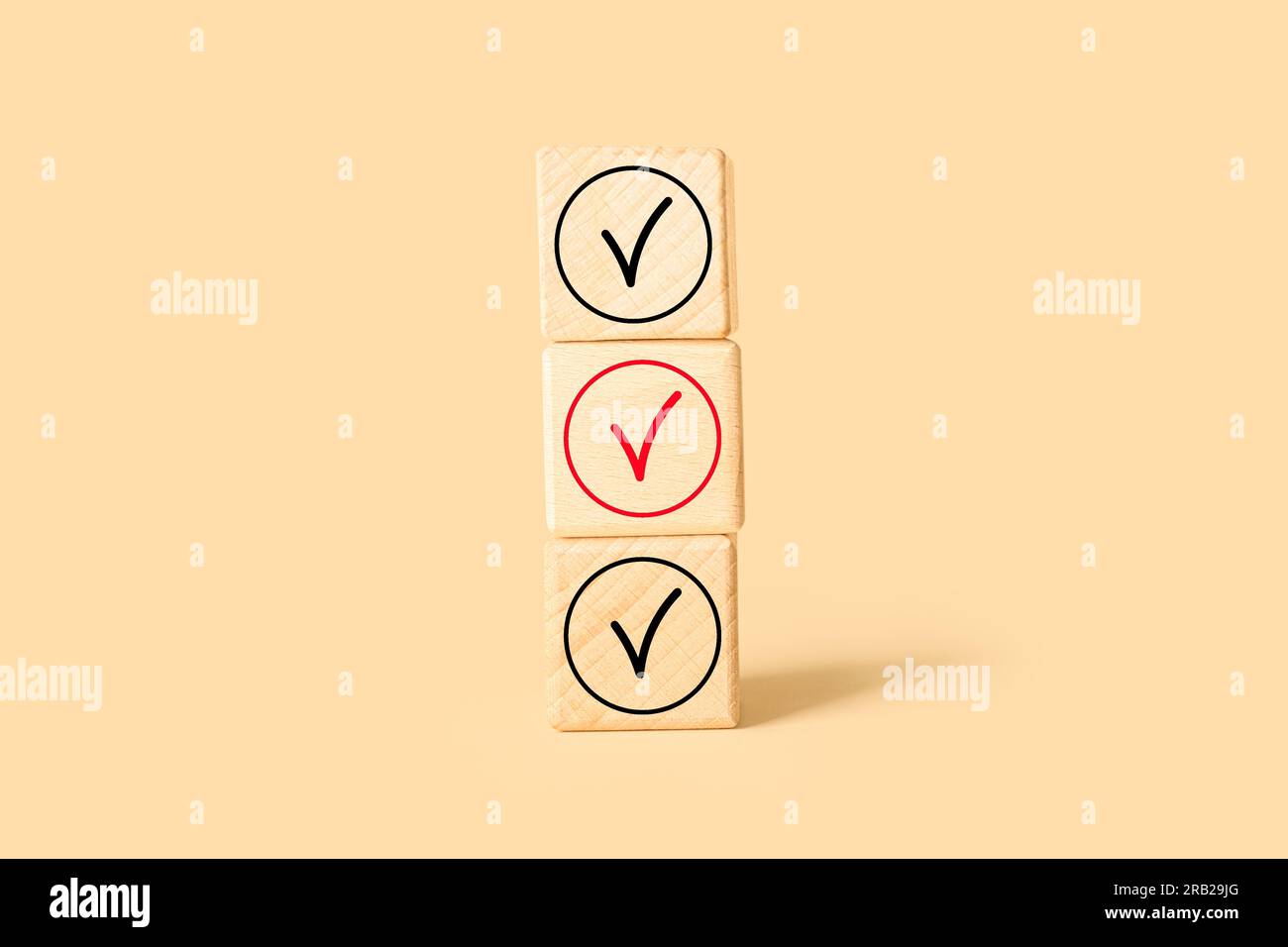 Wooden cubes with check marks on beige background Stock Photo - Alamy