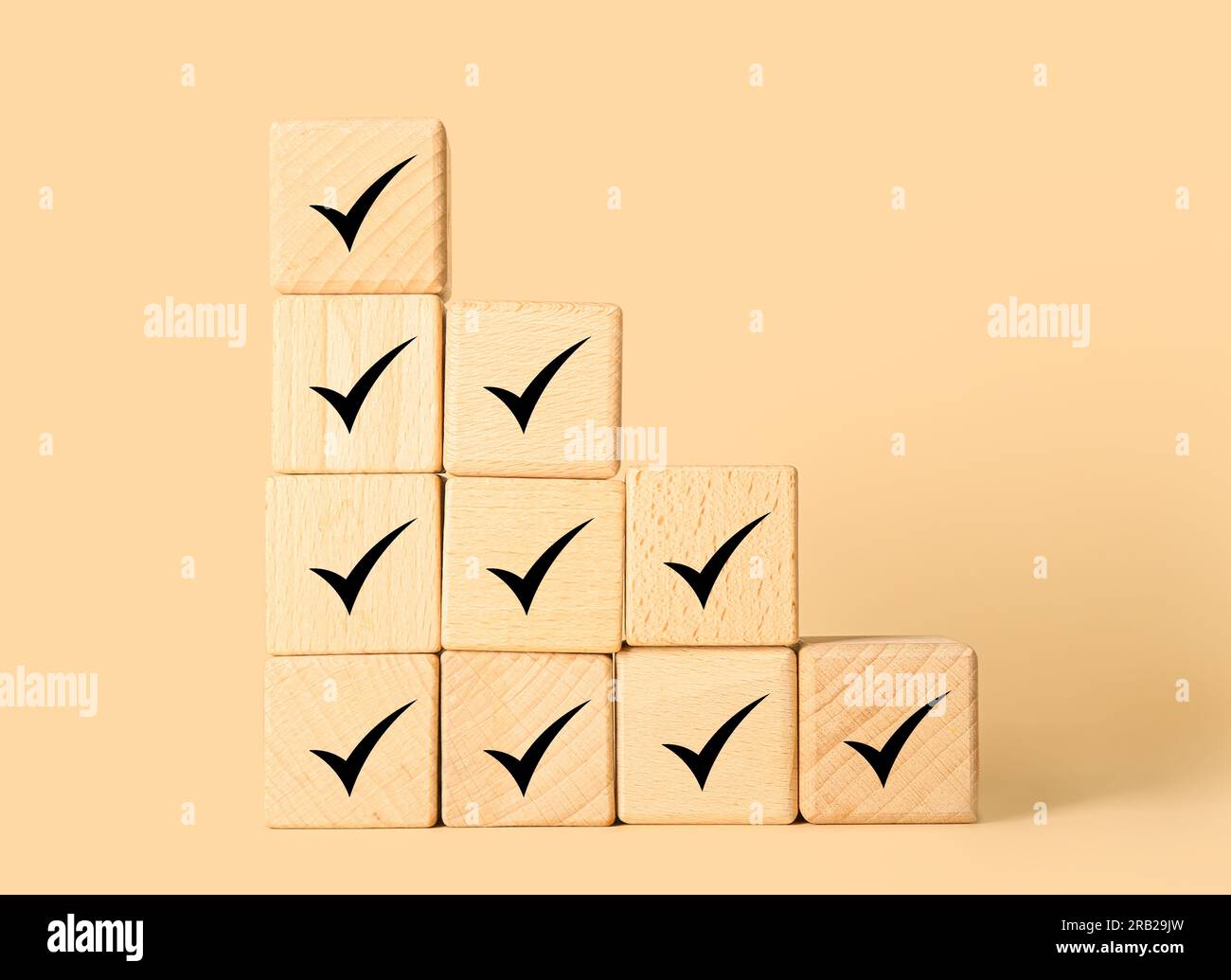 Wooden cubes with check marks on beige background Stock Photo - Alamy