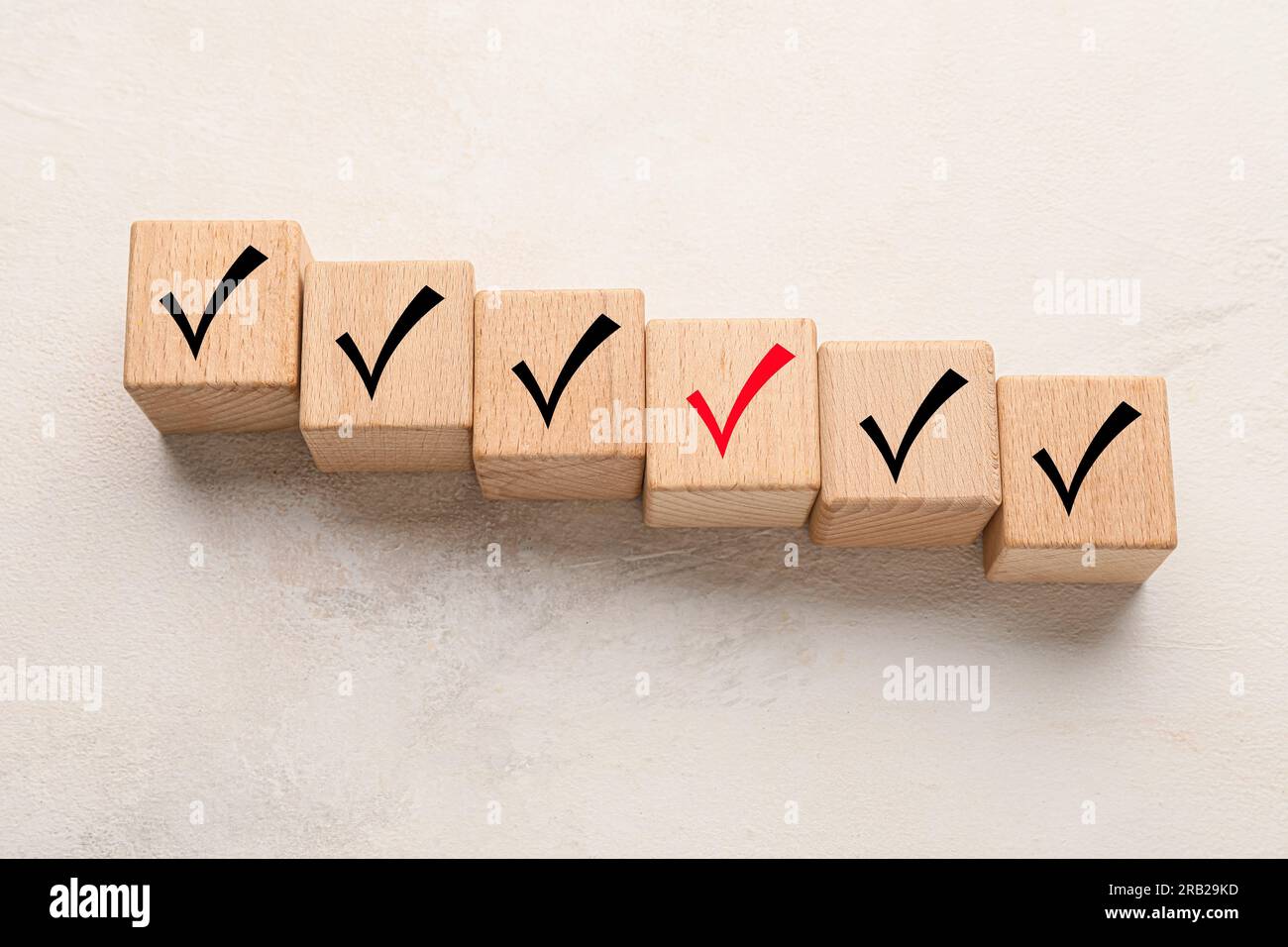 Wooden cubes with check marks on light background Stock Photo - Alamy