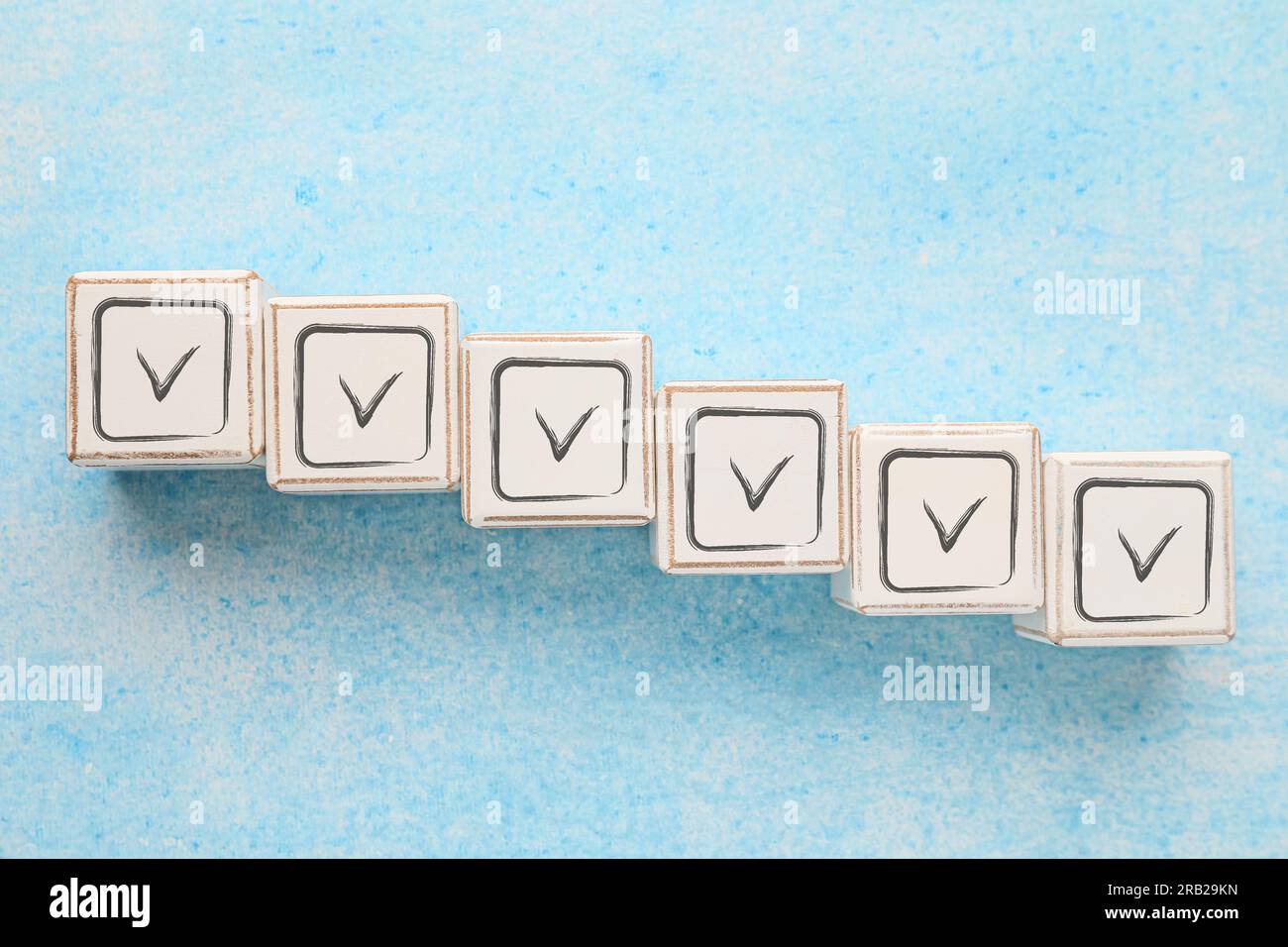White cubes with check marks on blue background Stock Photo - Alamy