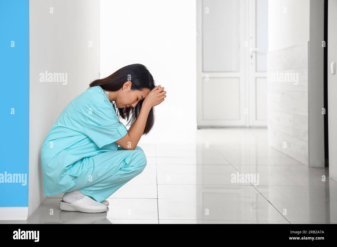 Stressed female Asian medical intern in clinic Stock Photo - Alamy