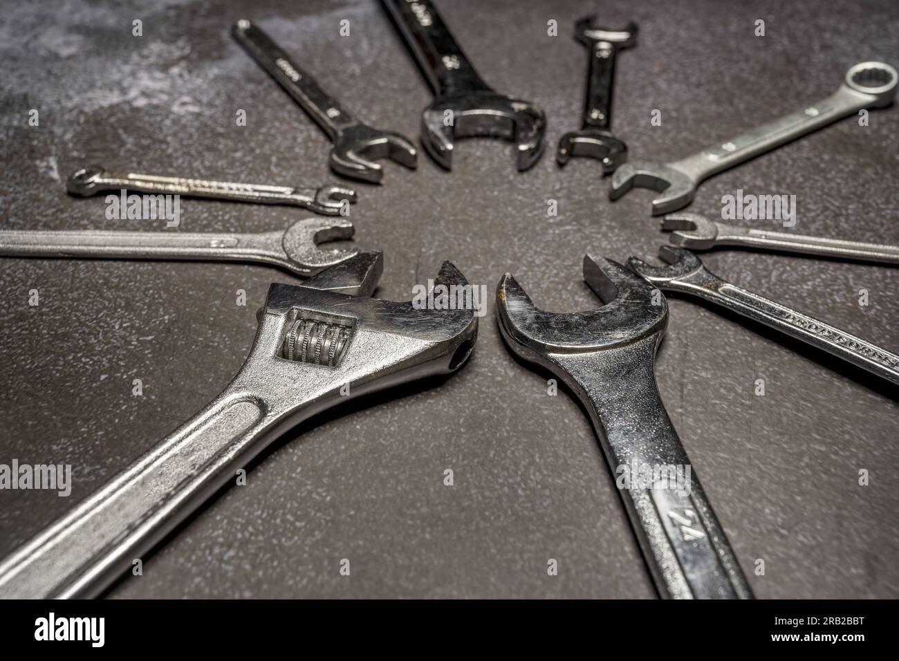 The heads of a wrench of different pitches and a small wrench on a gray ...