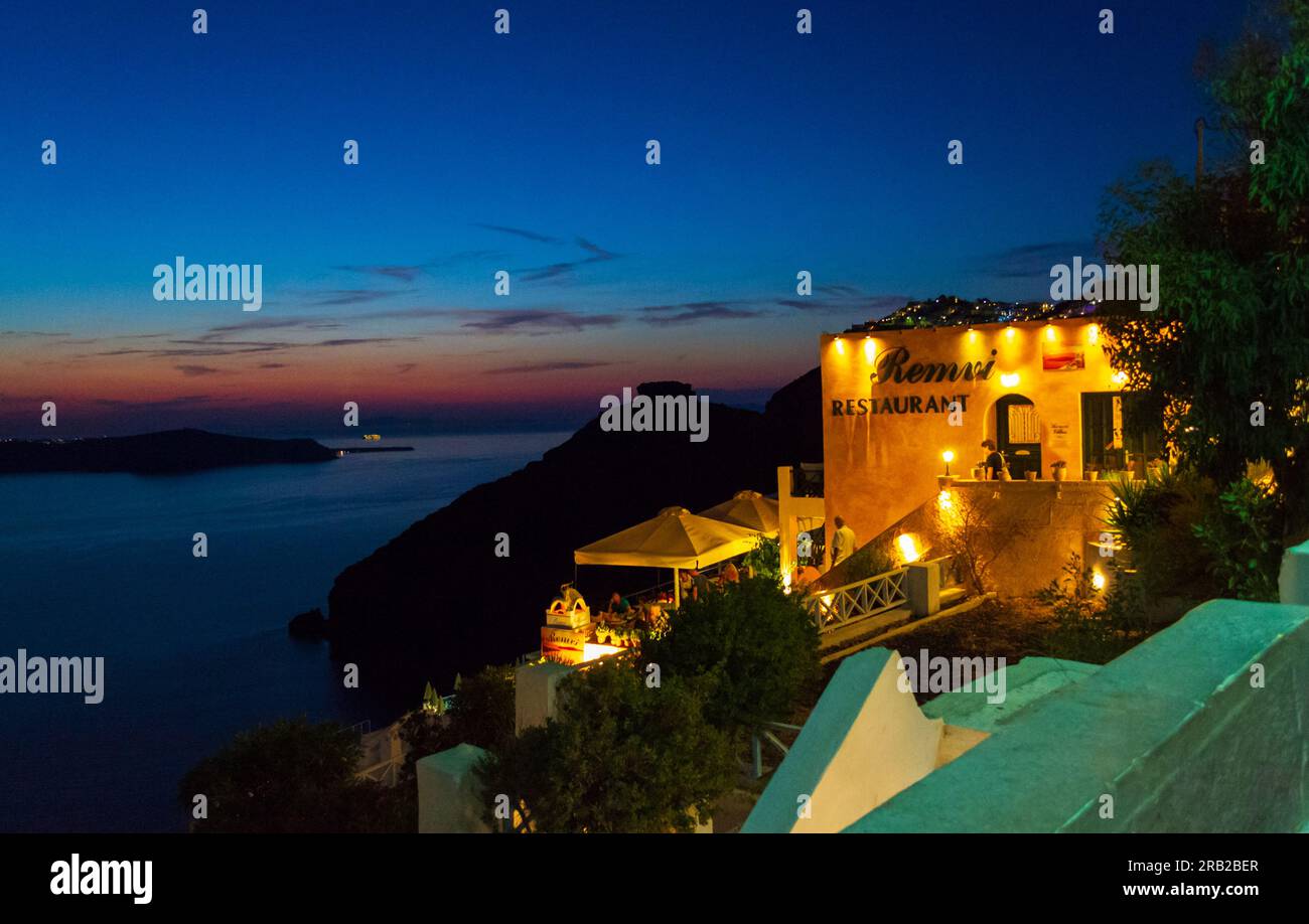 Night street view of Fira on the clifftop overlooking Santorini’s ...