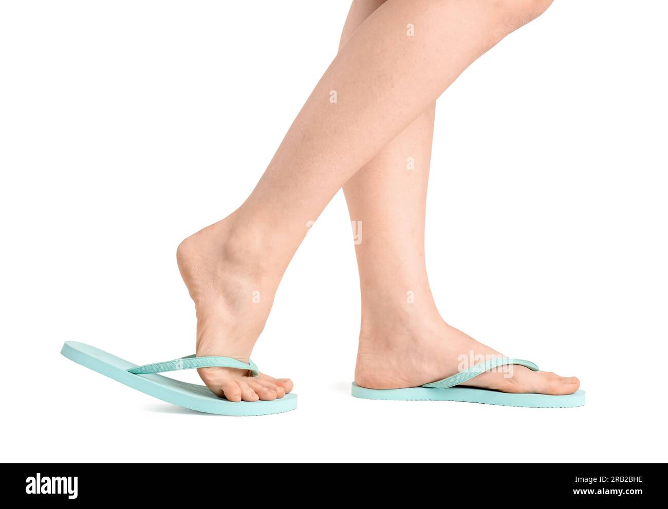 Female legs in flip-flops on white background Stock Photo - Alamy