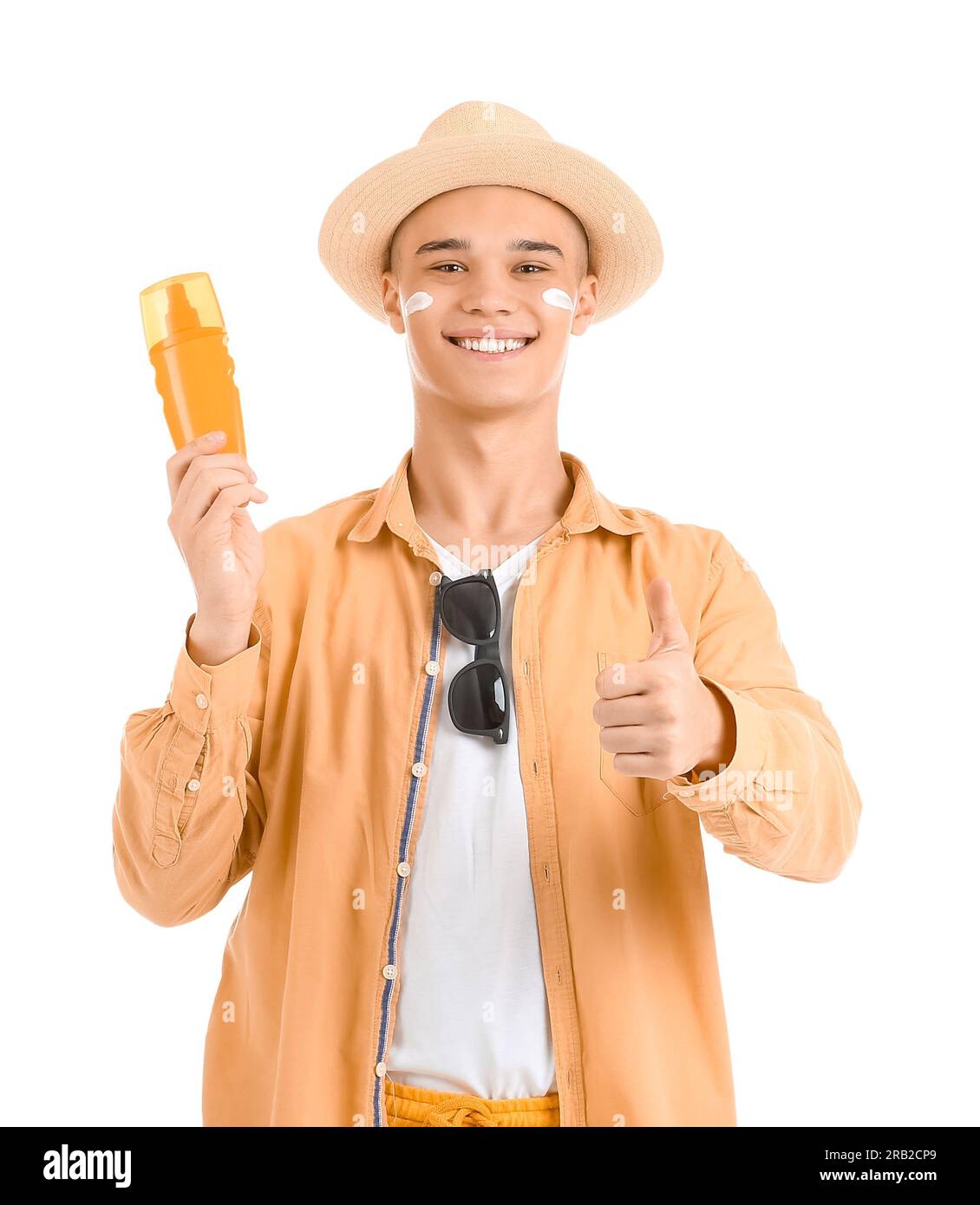 Happy young man with sunscreen cream on his face showing thumb-up ...
