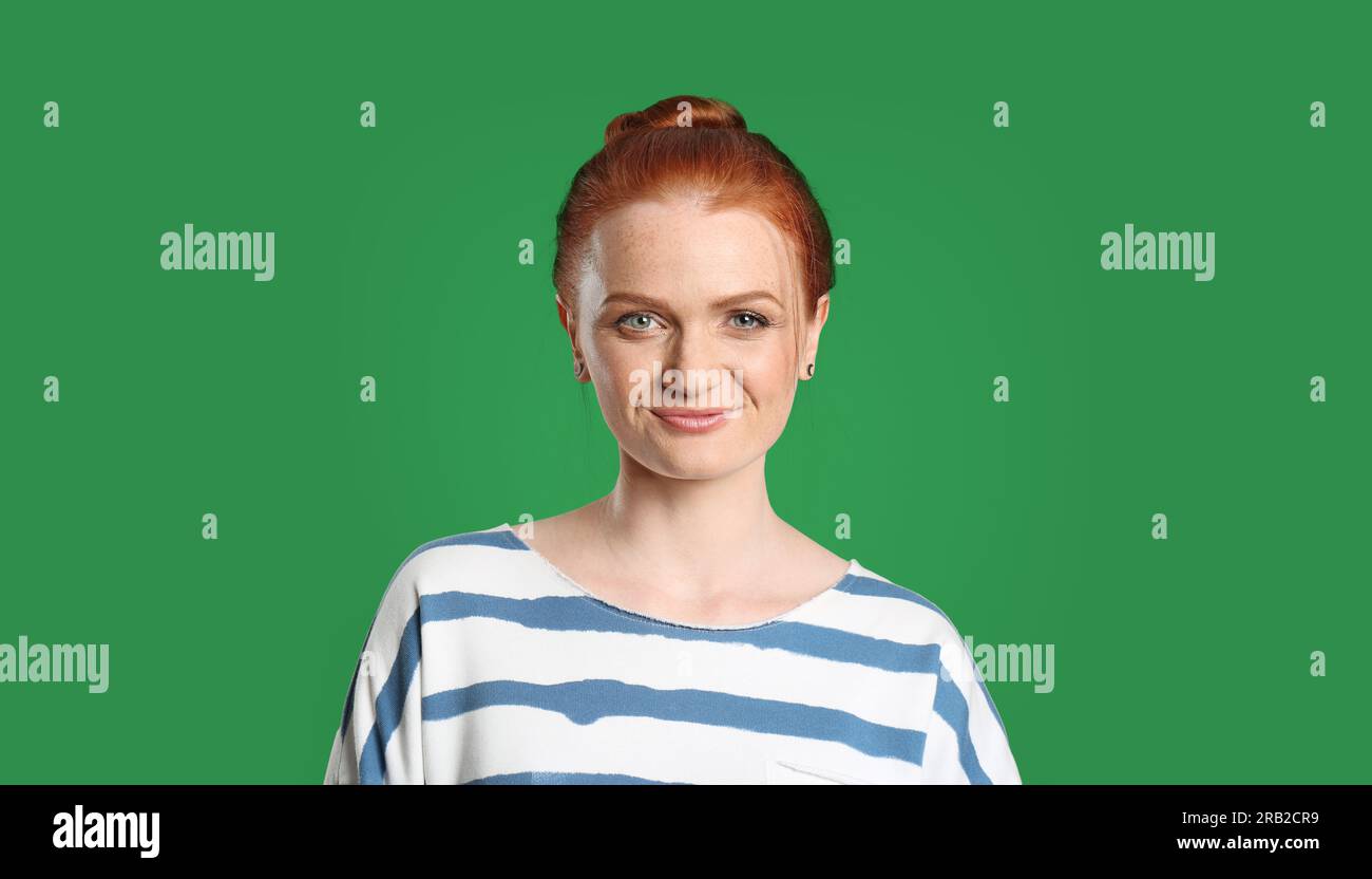 Chroma key compositing. Beautiful young woman with red hair against ...