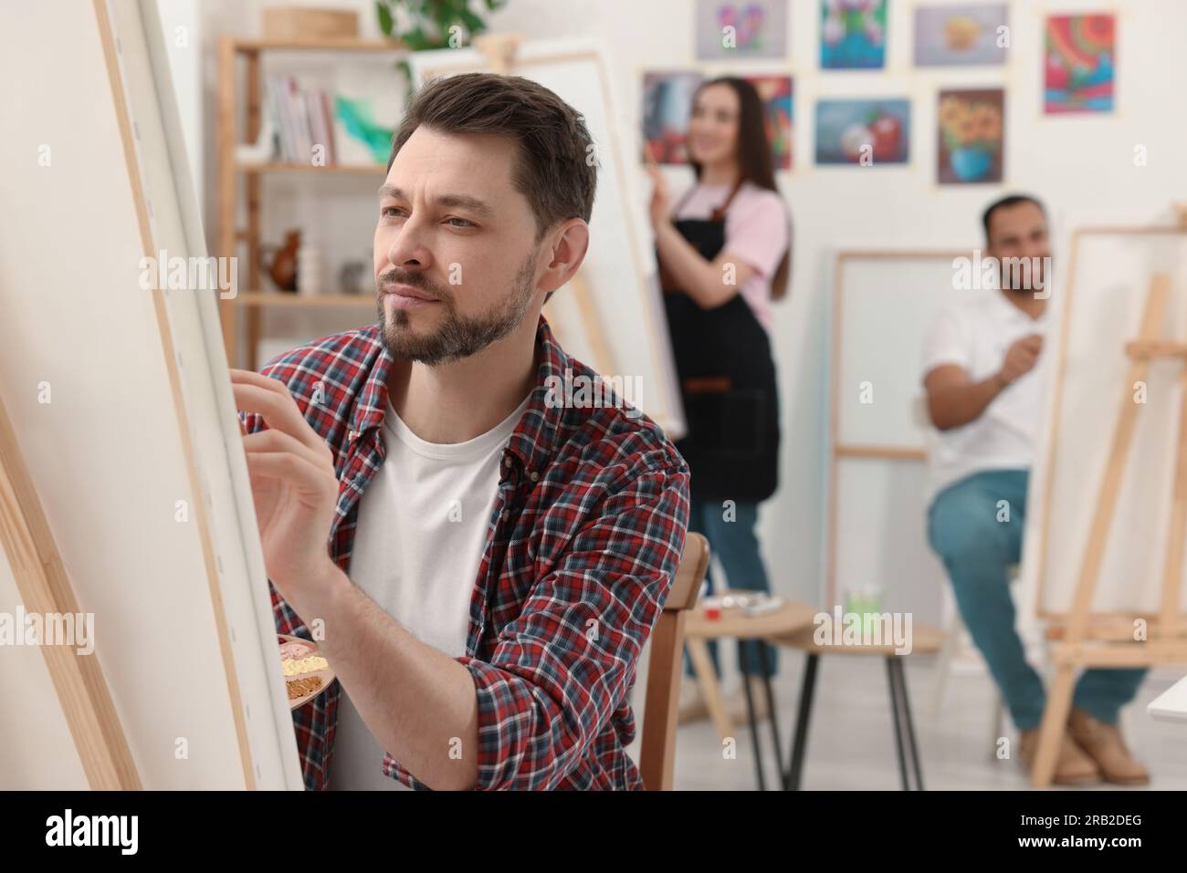 Group of students attending painting class in studio. Creative hobby ...