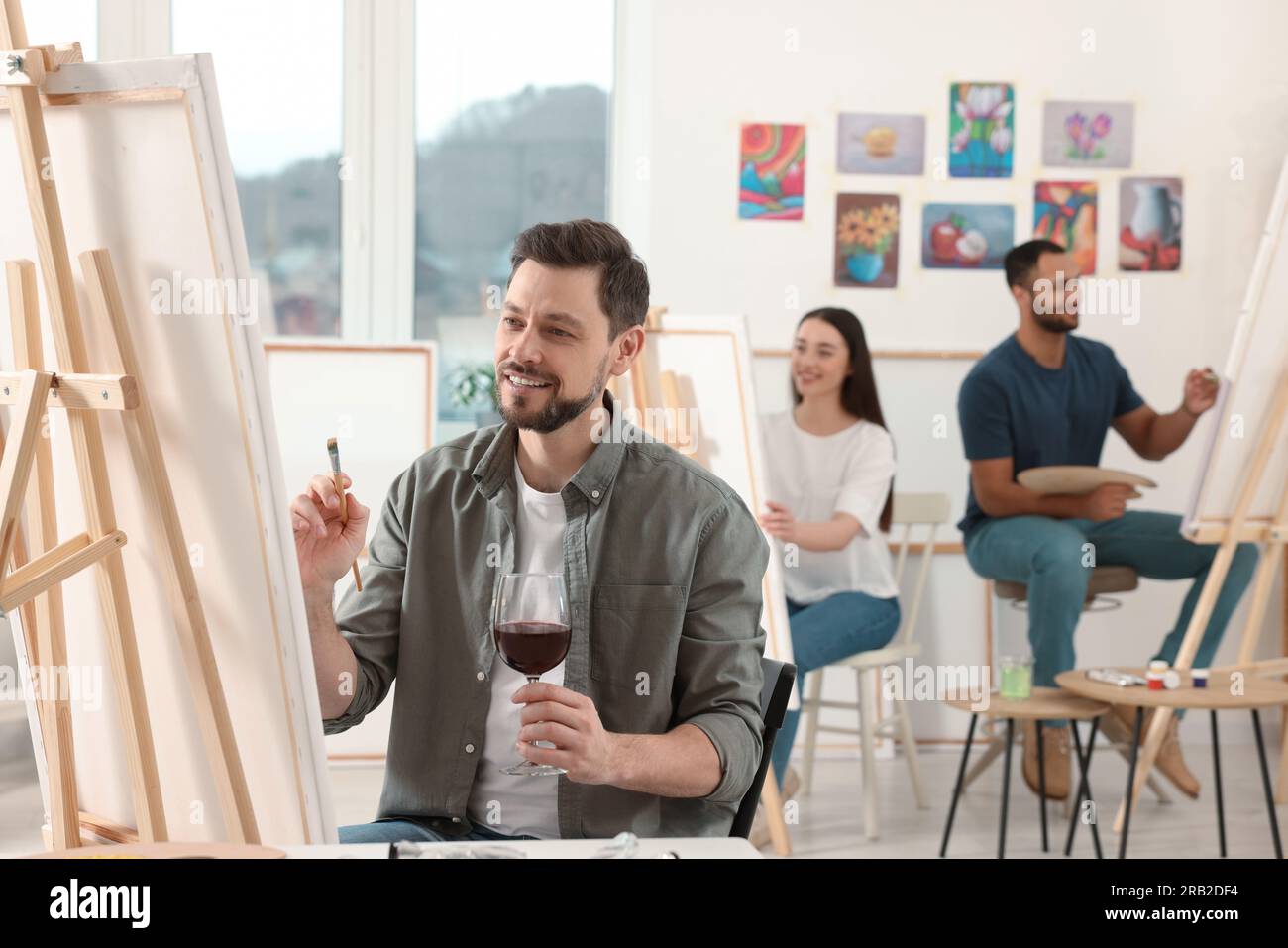 Group of students attending painting class in studio. Creative hobby ...