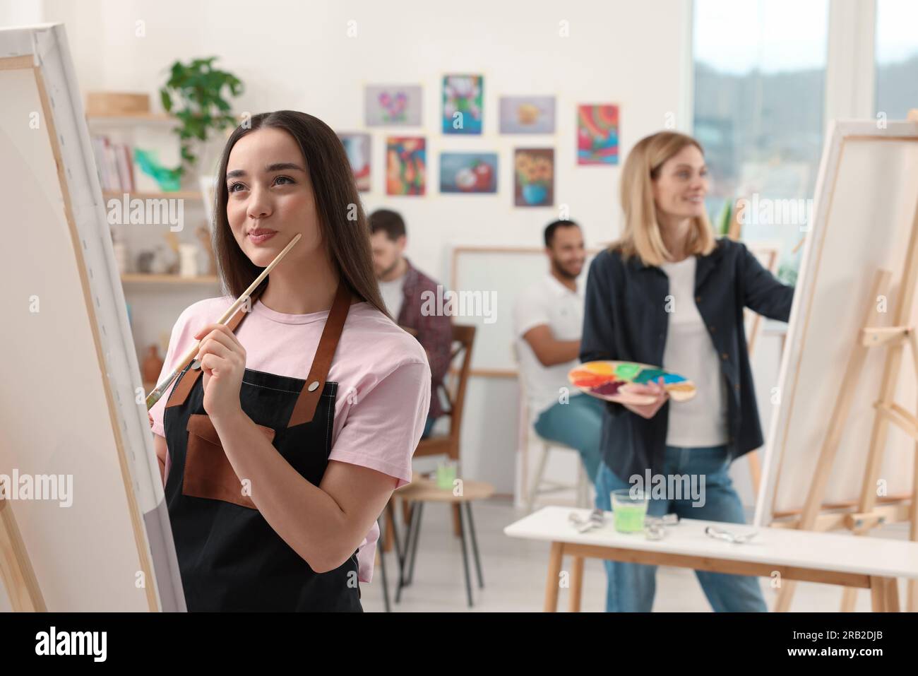Group of students attending painting class in studio. Creative hobby ...