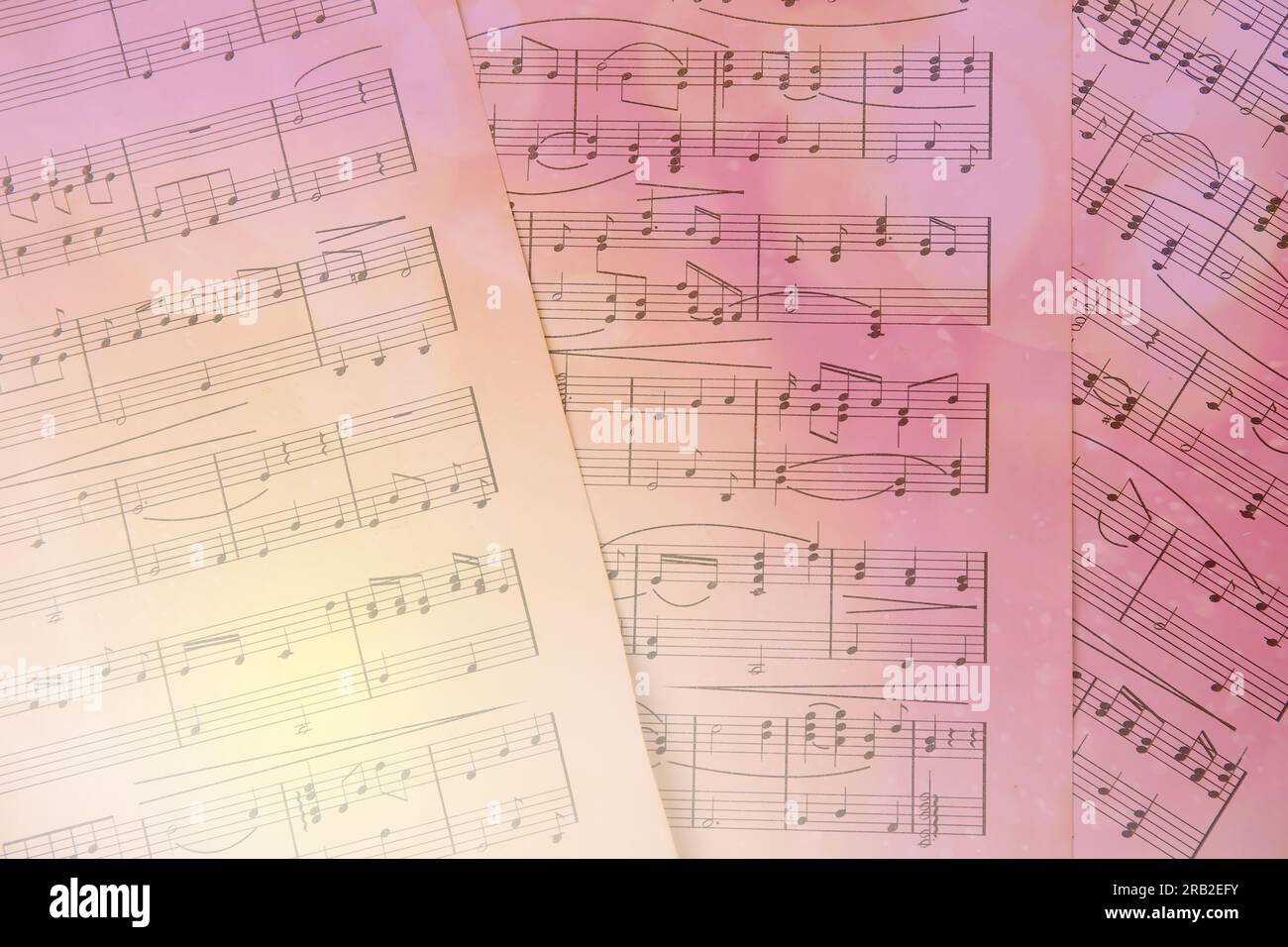 Sheets with music notes as background, top view. Bokeh and color tone ...