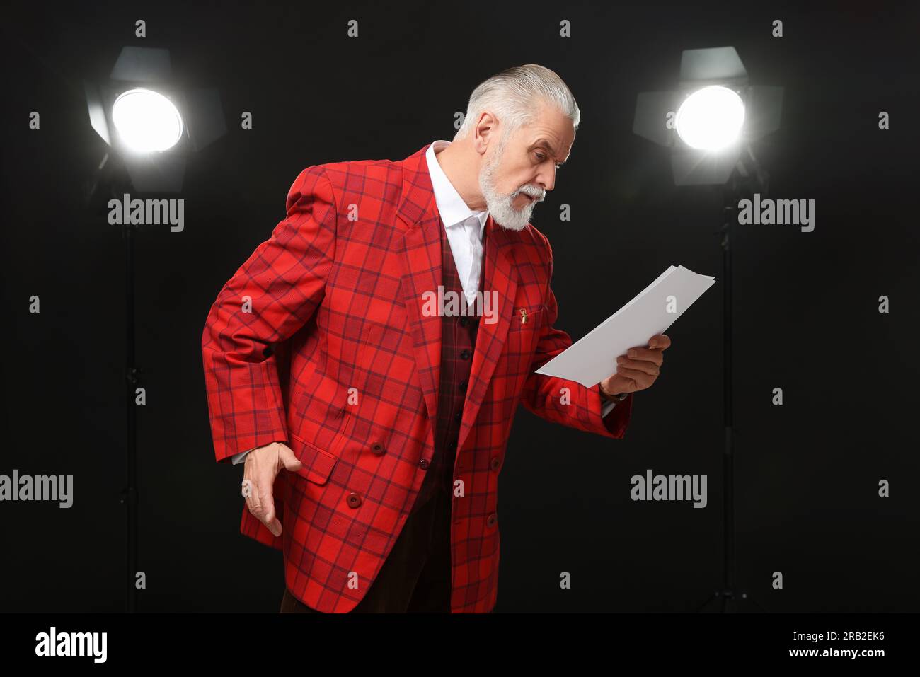 Senior actor with script performing on stage Stock Photo - Alamy