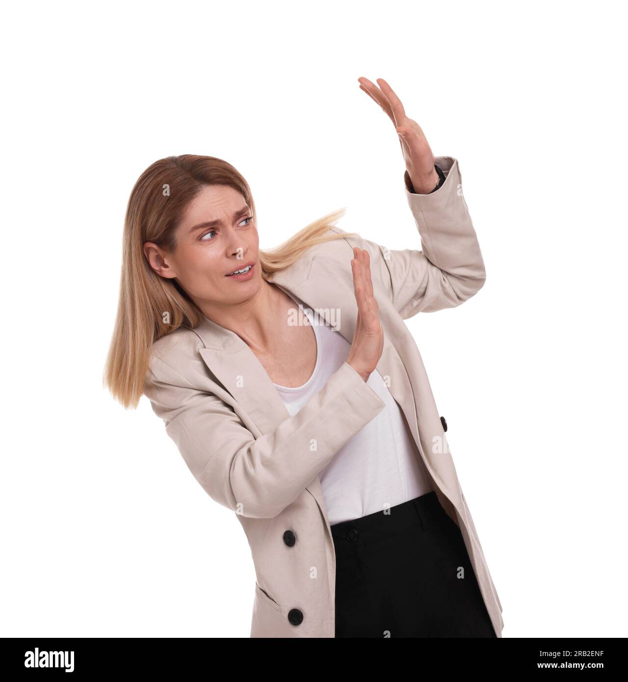 Scared businesswoman avoiding something on white background Stock Photo ...