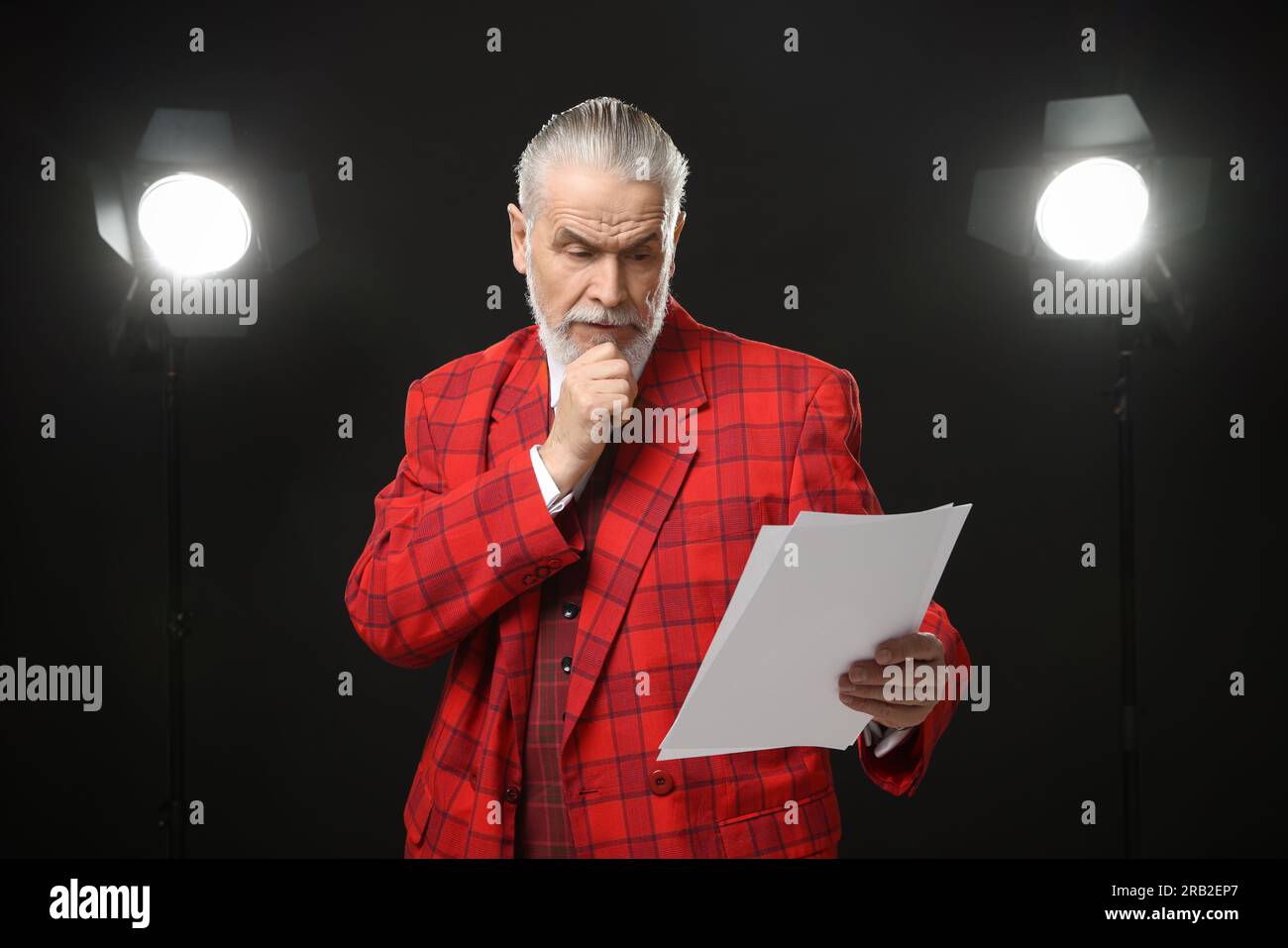 Senior actor with script performing on stage Stock Photo - Alamy