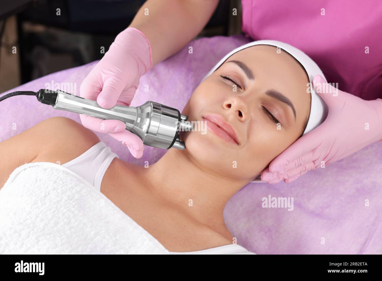 Young woman undergoing cosmetic procedure in beauty salon. Microcurrent therapy Stock Photo - Alamy
