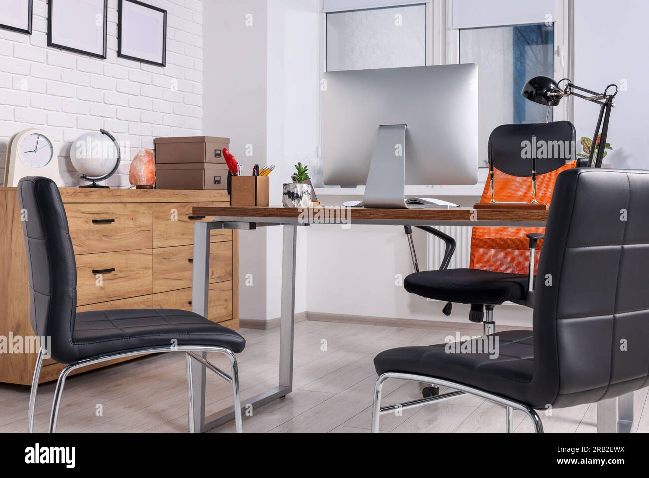 Stylish director's workplace with comfortable desk, computer and chairs ...