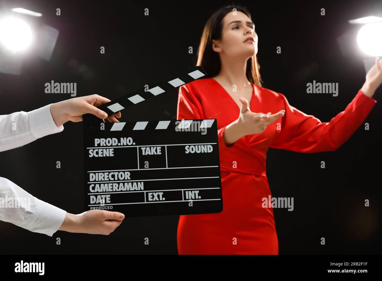 Emotional actress performing while second assistant camera holding ...