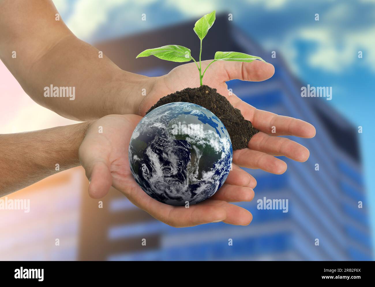 Make Earth green. Man holding globe and soil with seedling against ...