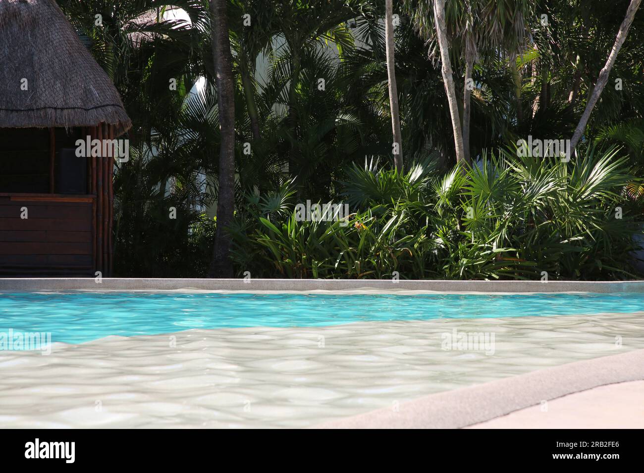 Outdoor swimming pool at resort on sunny day Stock Photo - Alamy