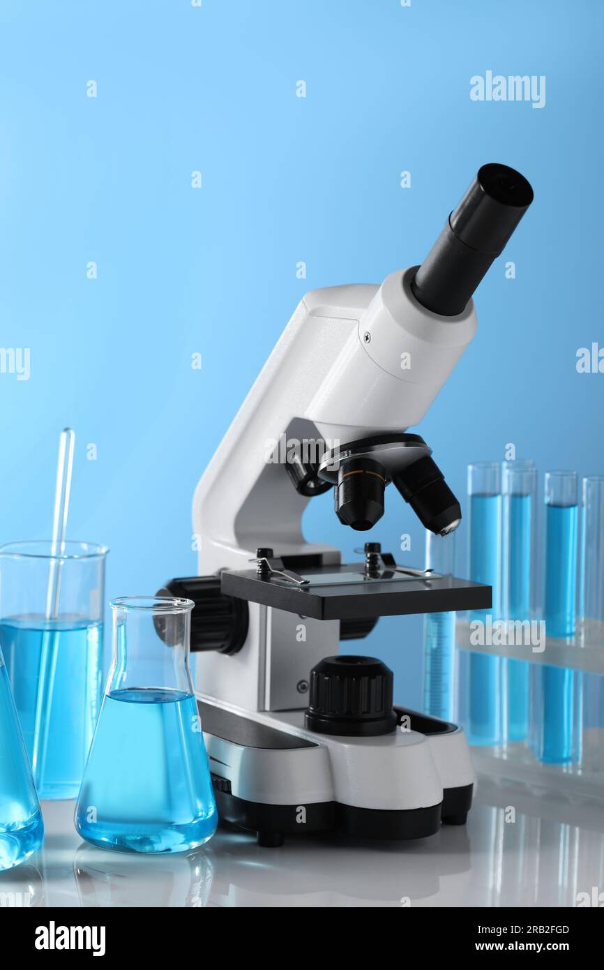 Different laboratory glassware, test tubes with light blue liquid and ...