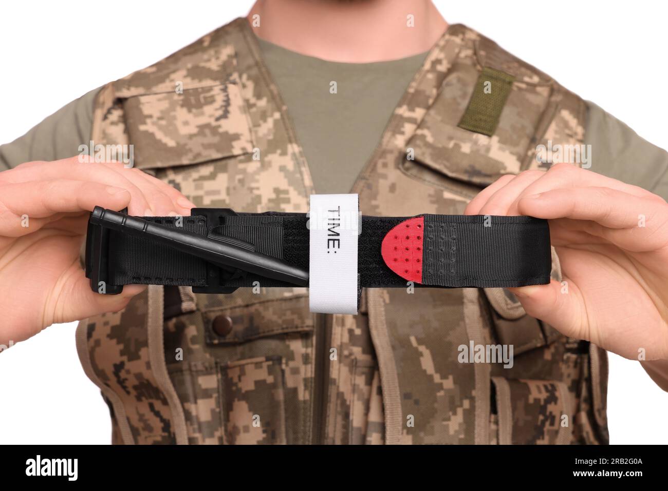 Soldier in military uniform holding medical tourniquet on white ...