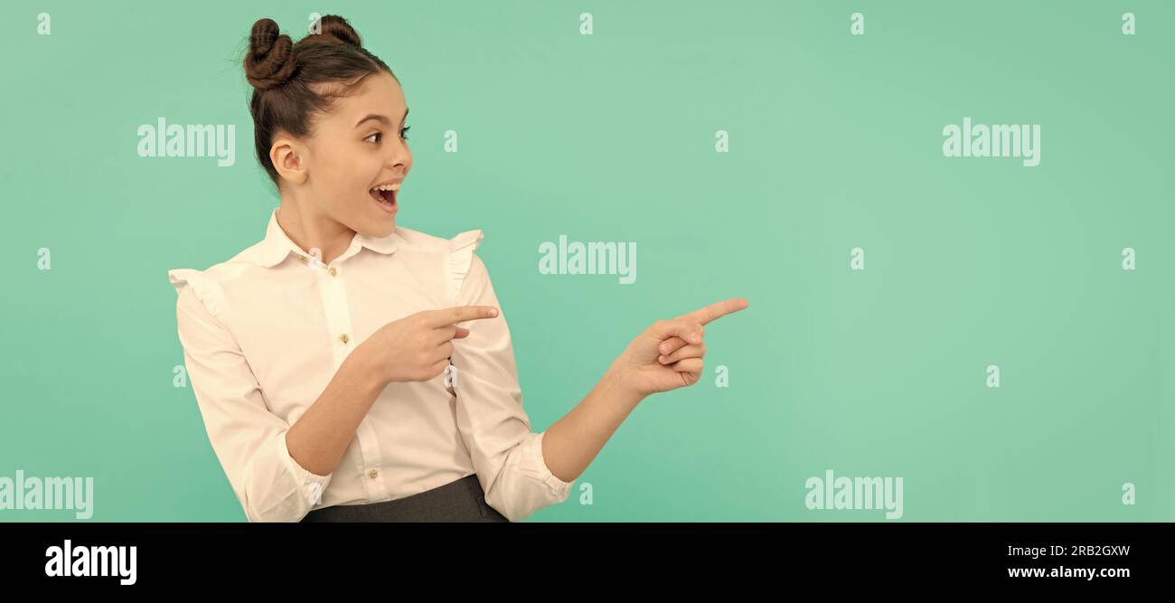 Exclusive. Happy schoolchild point fingers. Pointing gesture. Pointing ...