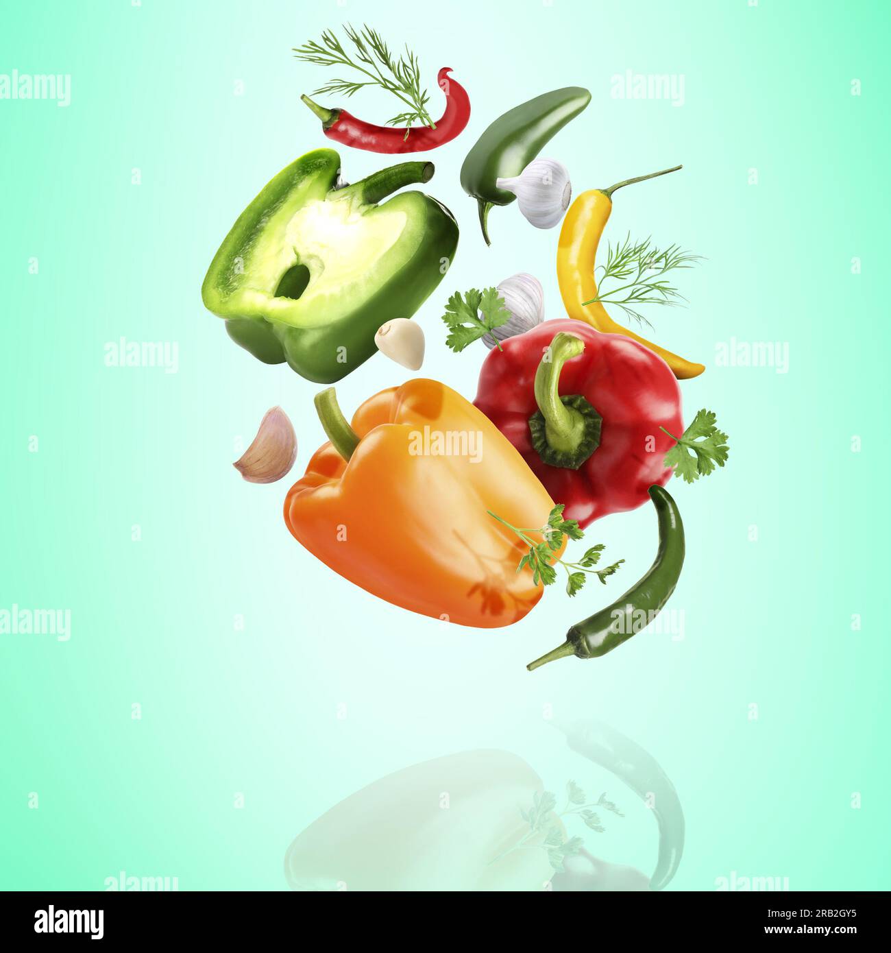 Many fresh vegetables and herbs falling on turquoise background Stock ...