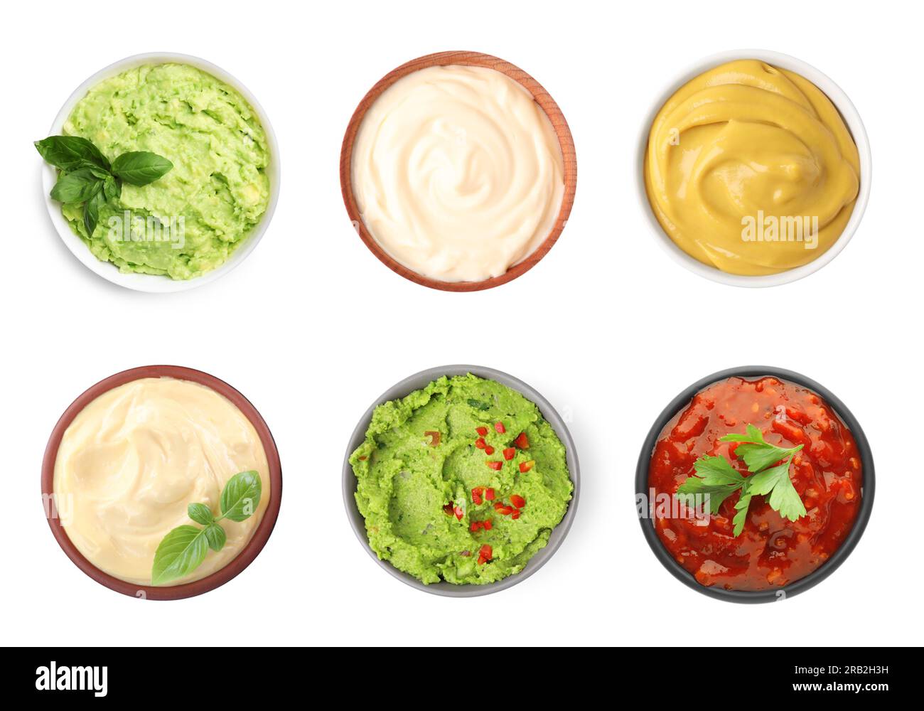 Set of guacamole and different sauces on white background, top view ...