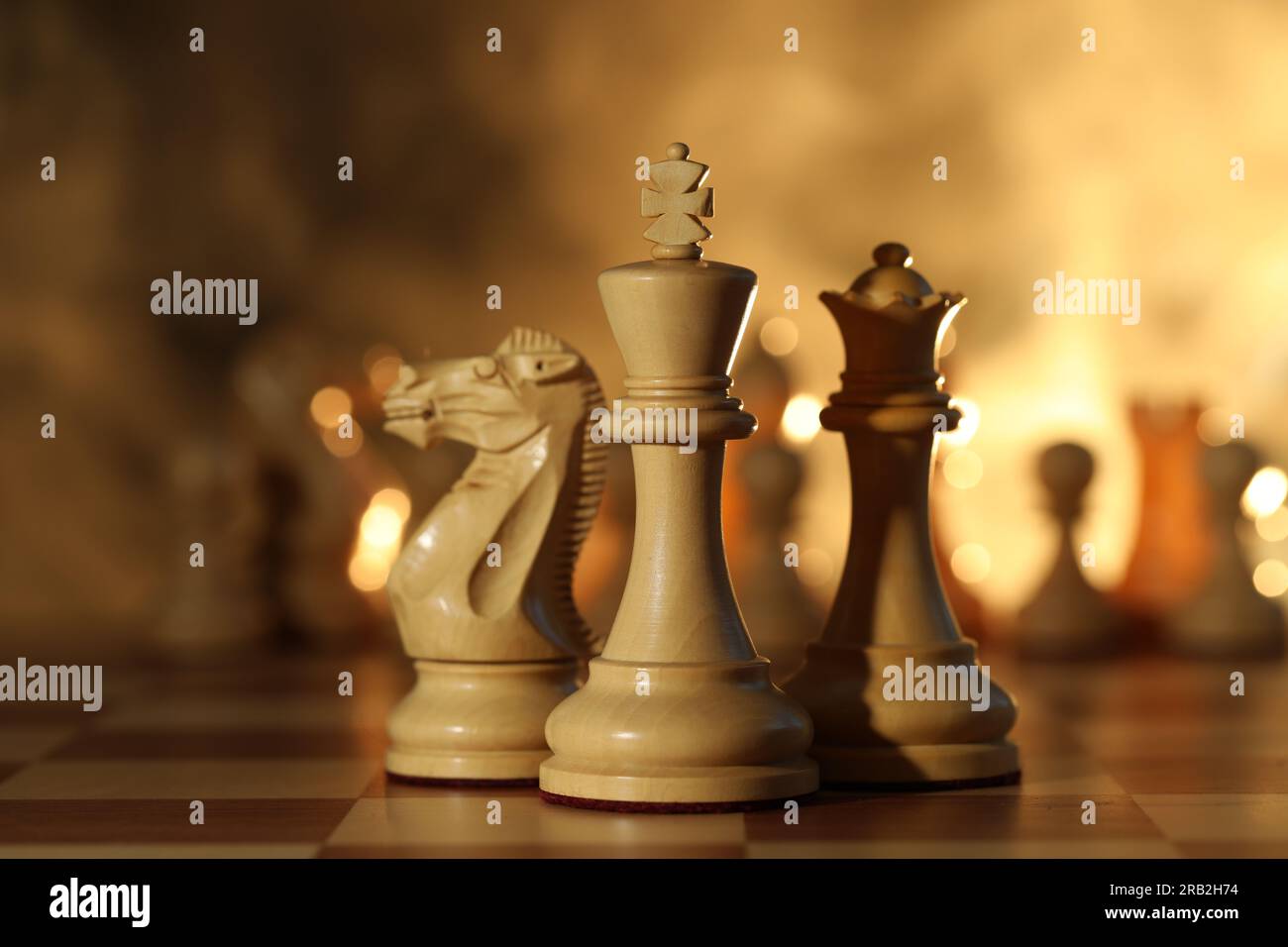 Wooden king, queen and knight on chessboard, closeup Stock Photo - Alamy