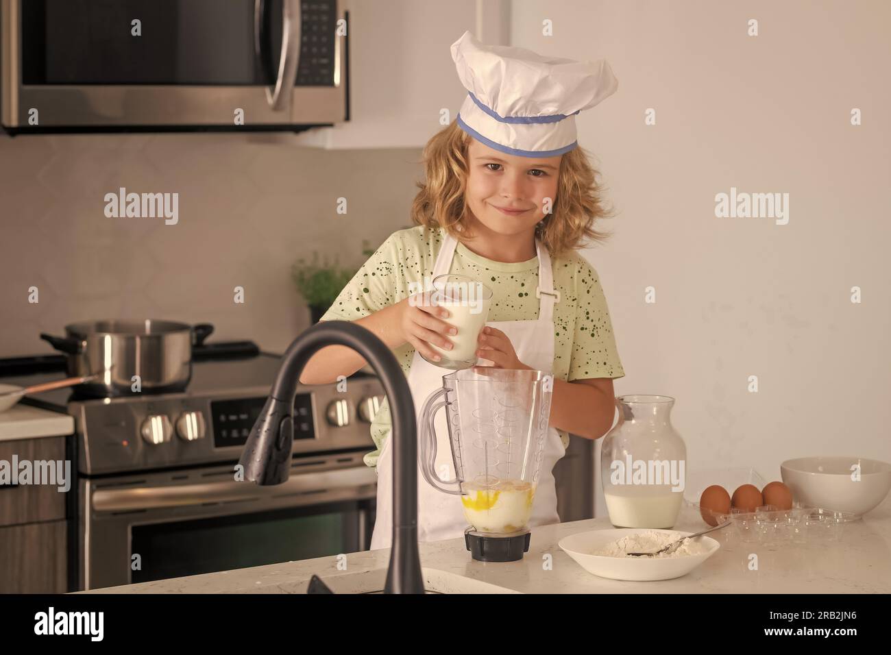 Children cooking in the kitchen. Funny kid chef cook cookery at kitchen ...