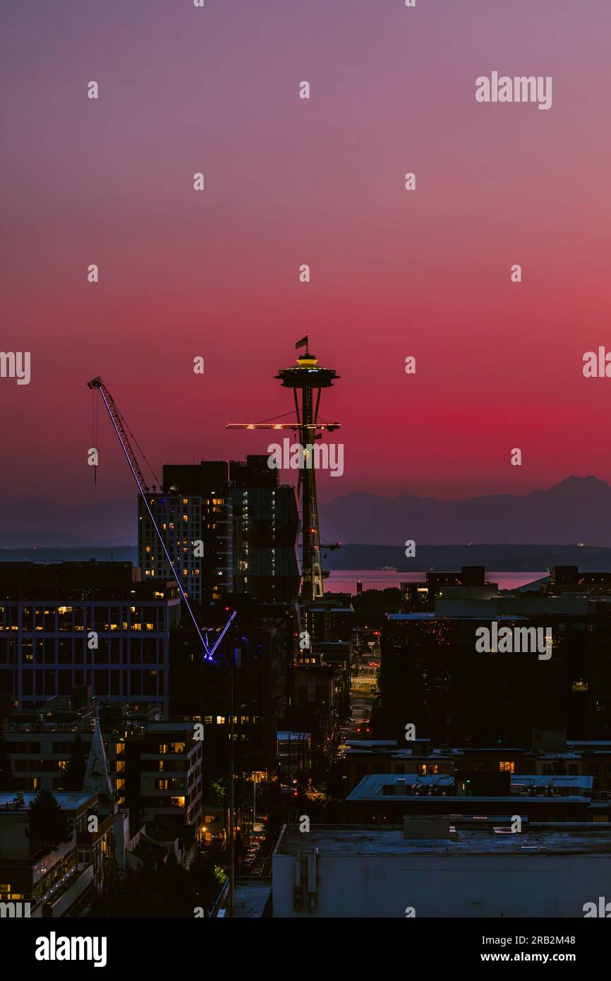view of pink sunset, Seattle Space Needle, downtown construction from ...