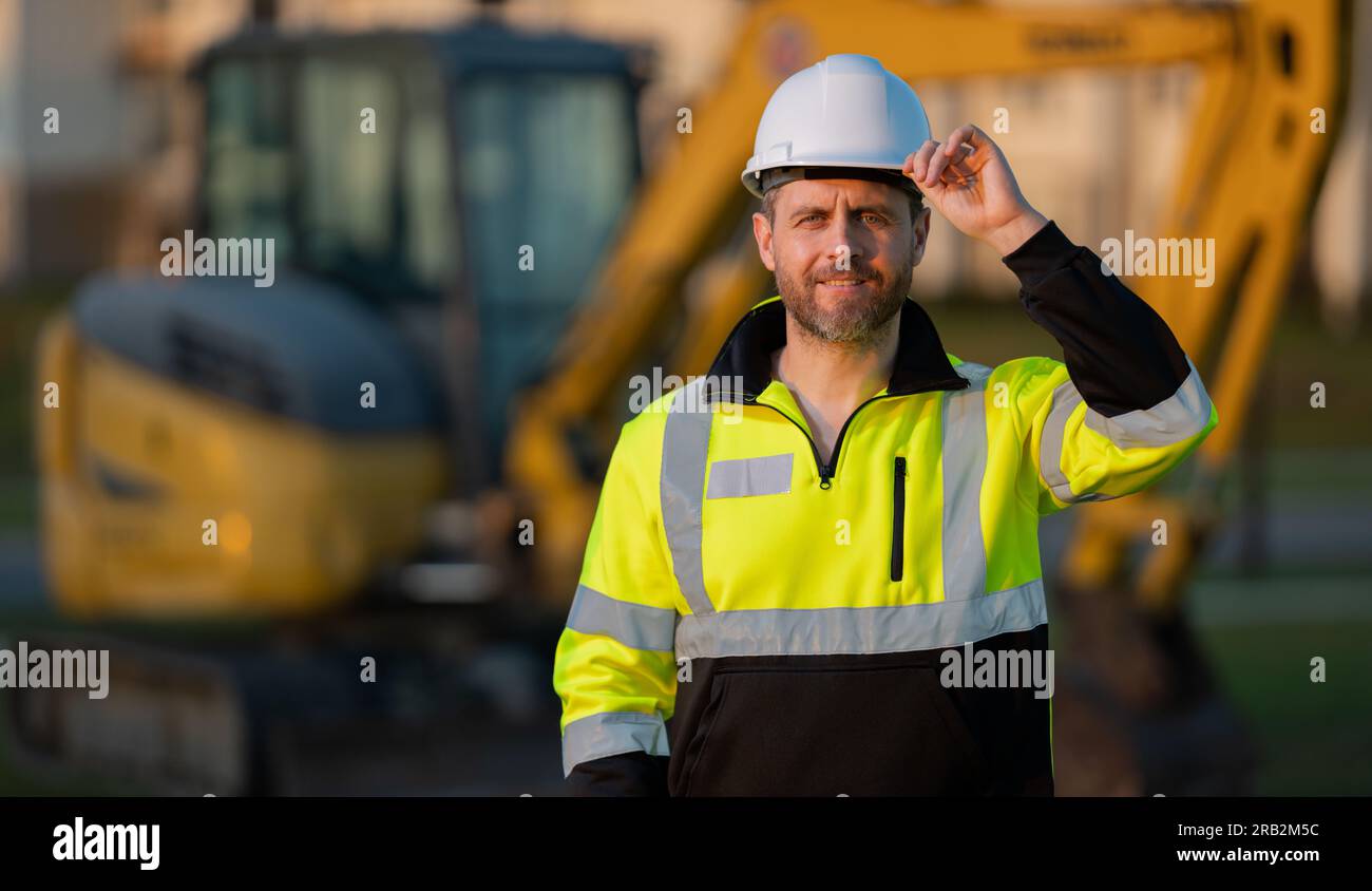 Builder in a construction site. Builder with excavator ready to build ...