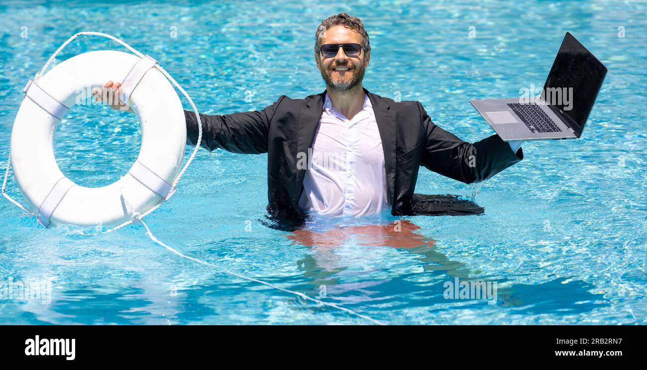 Helping business. Business man in suit hold laptop and help lifebuoy in ...