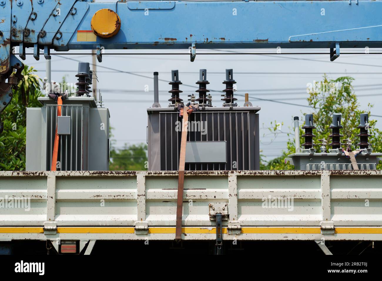 power transformer strapped on a truck and crane arm Stock Photo - Alamy