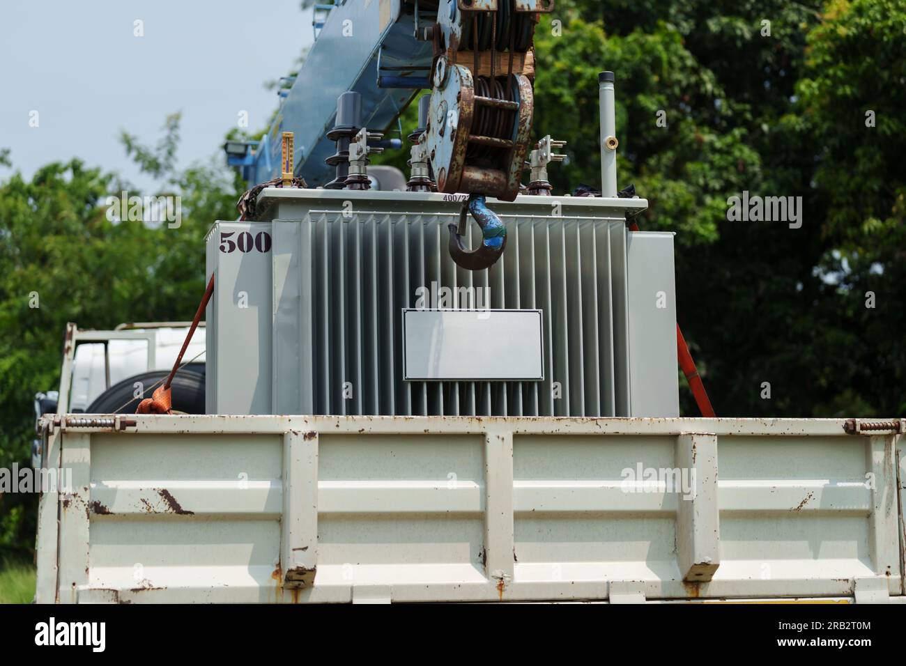 power transformer strapped on a truck and crane arm Stock Photo - Alamy