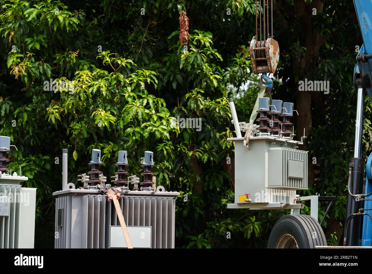 crane hook lifts up the distribution transformer Stock Photo - Alamy